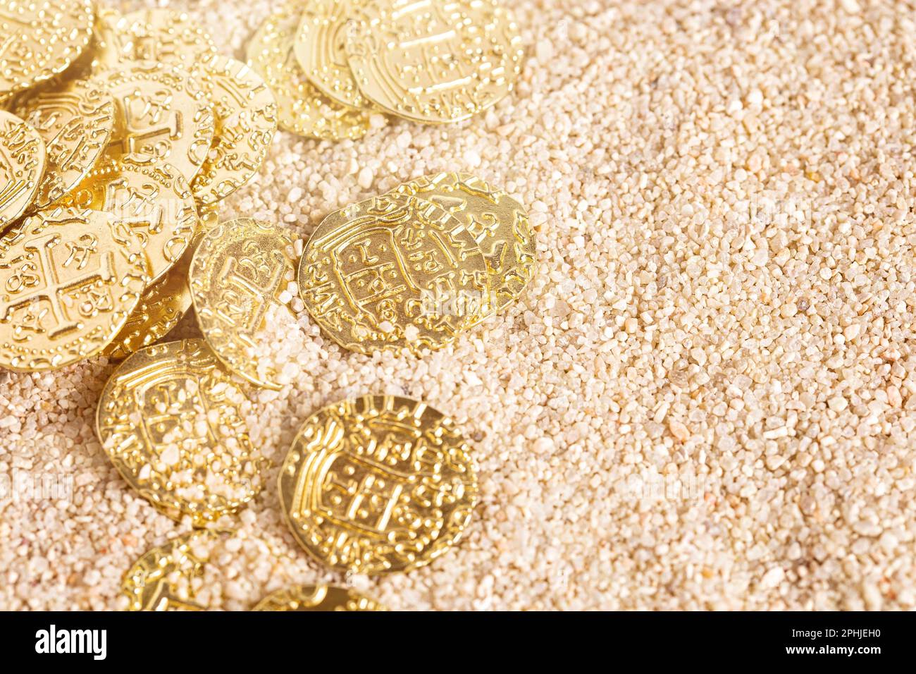 A Buried Pirate Treasure Gold Coins in the Sand on a Beach Stock Photo ...