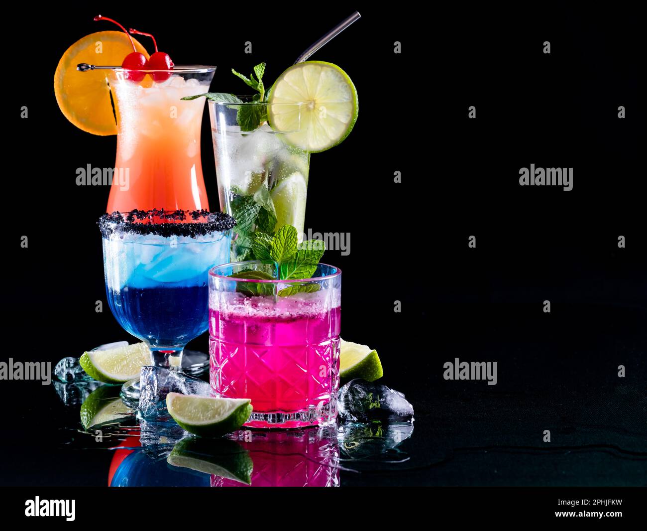Bright glowing refreshing cocktails on reflective glass with copy space ...