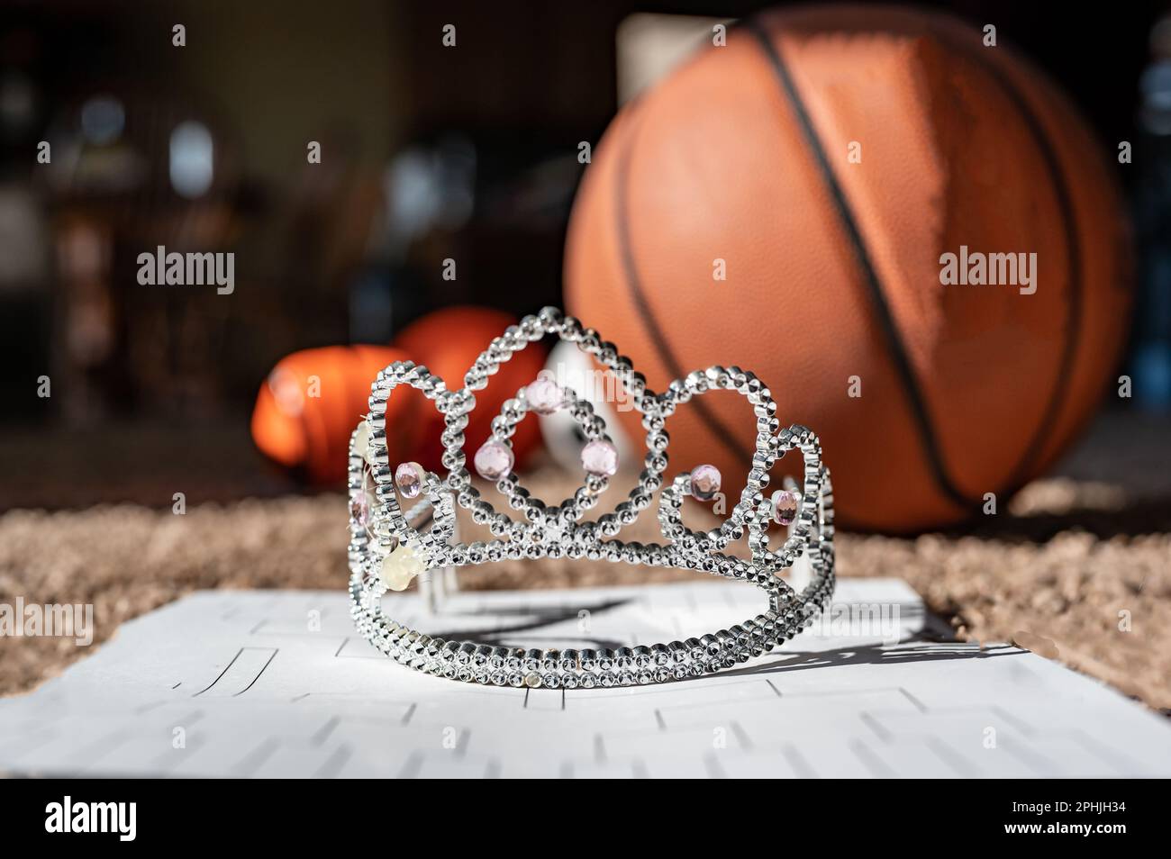 Basketball, tiara, and blank bracket signifying a Cinderella season ...