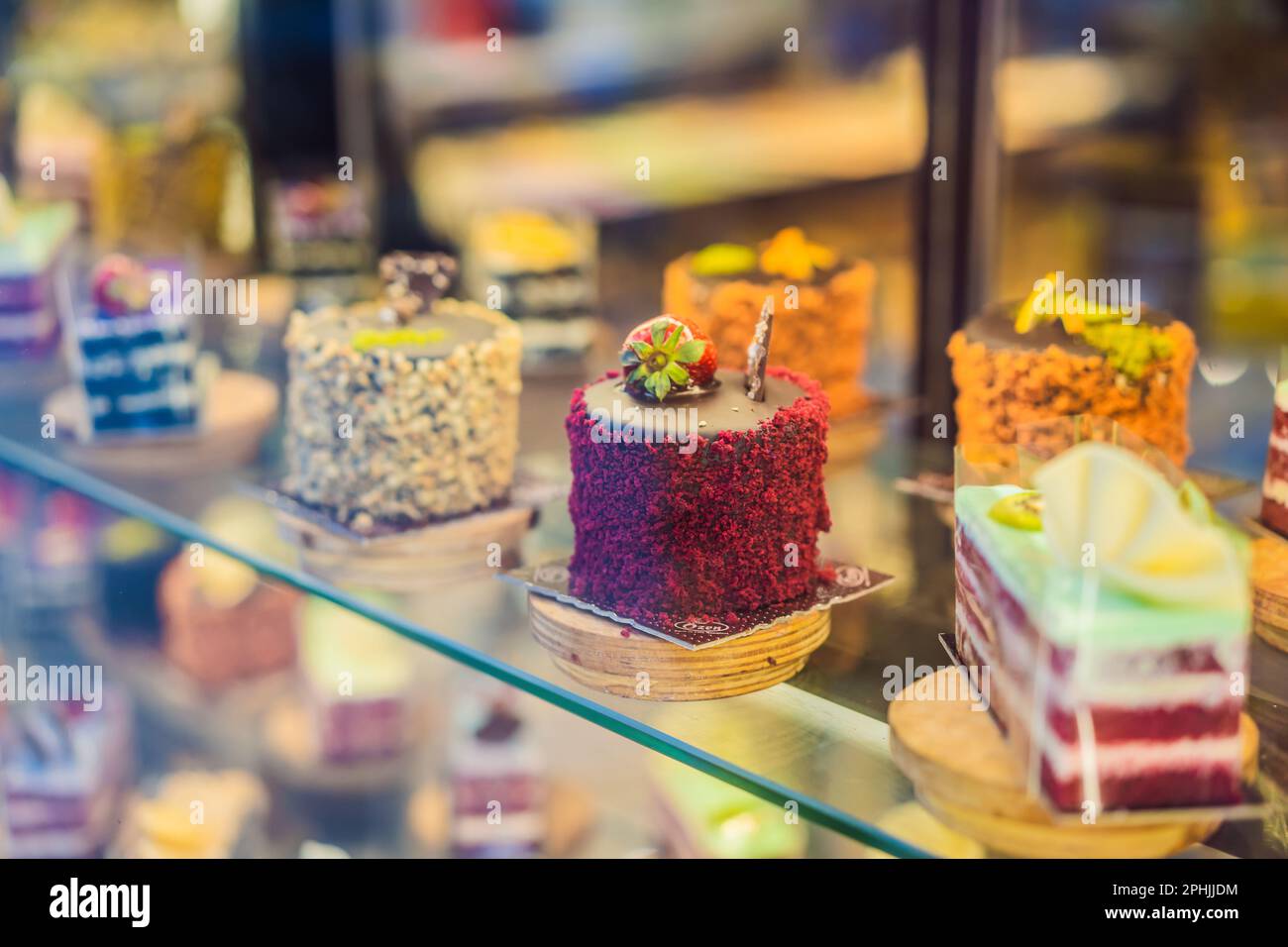 Different types of cakes in pastry shop glass display Stock Photo - Alamy