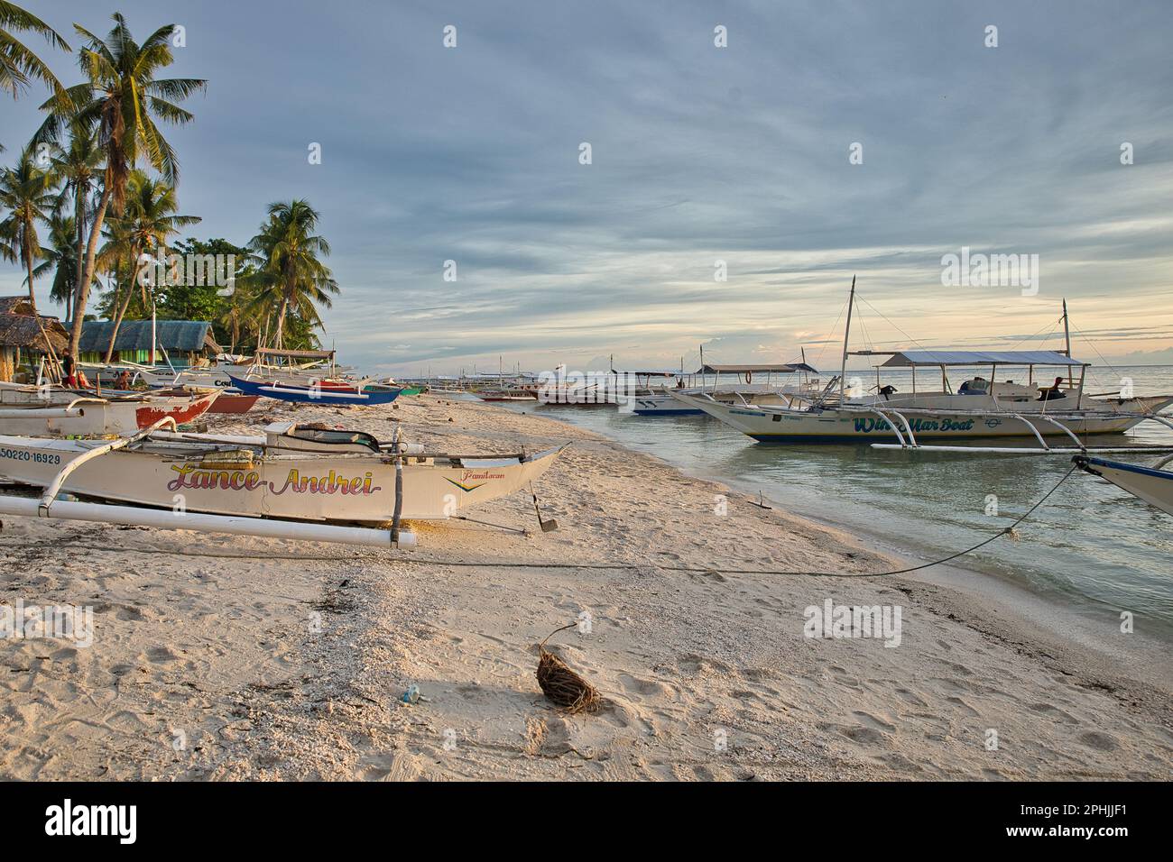 An idyllic white sand beach of Pamilacan Island in the Philippines with ...