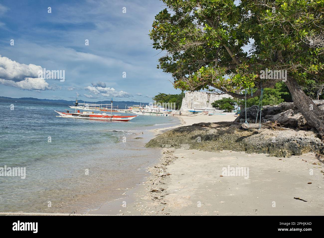 An idyllic white sand beach of Pamilacan Island in the Philippines with ...