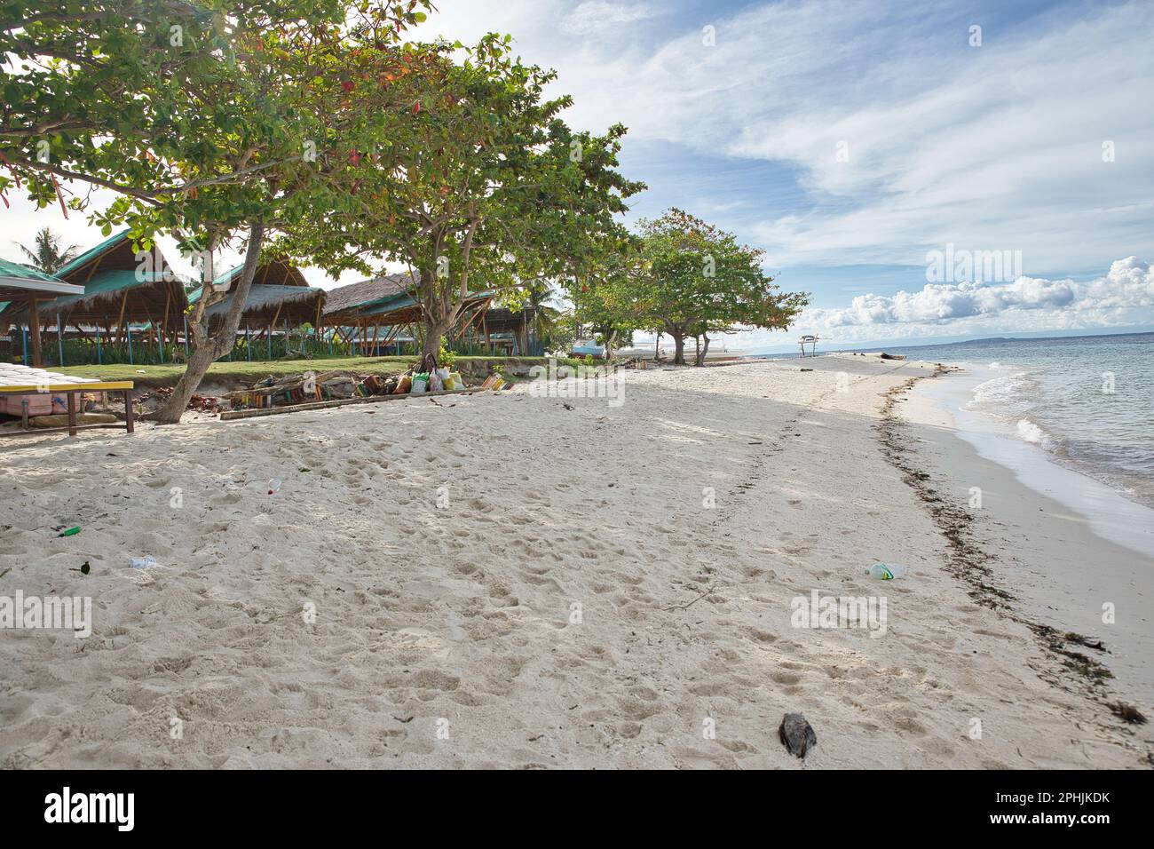 An idyllic white sand beach of Pamilacan Island in the Philippines with ...