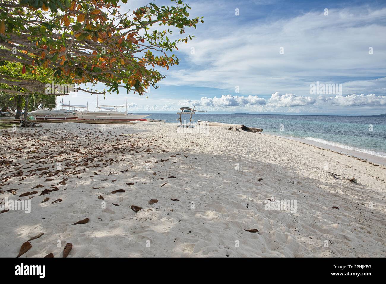An idyllic, secluded sandy beach of Pamilacan Island in the Philippines ...