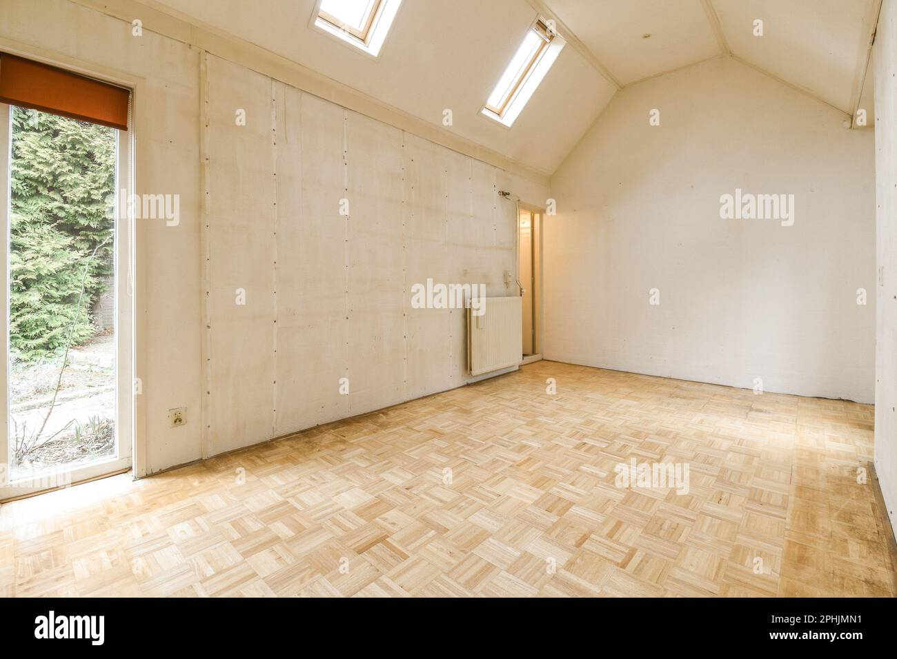 an unfinished room with wood flooring and walls being stripped down to ...