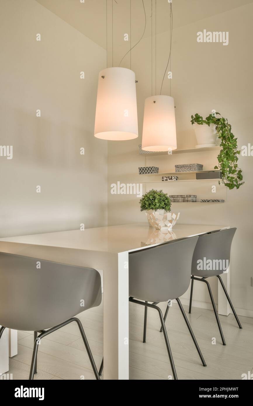 a dining room with two chairs and a table in front of the chair is a ...