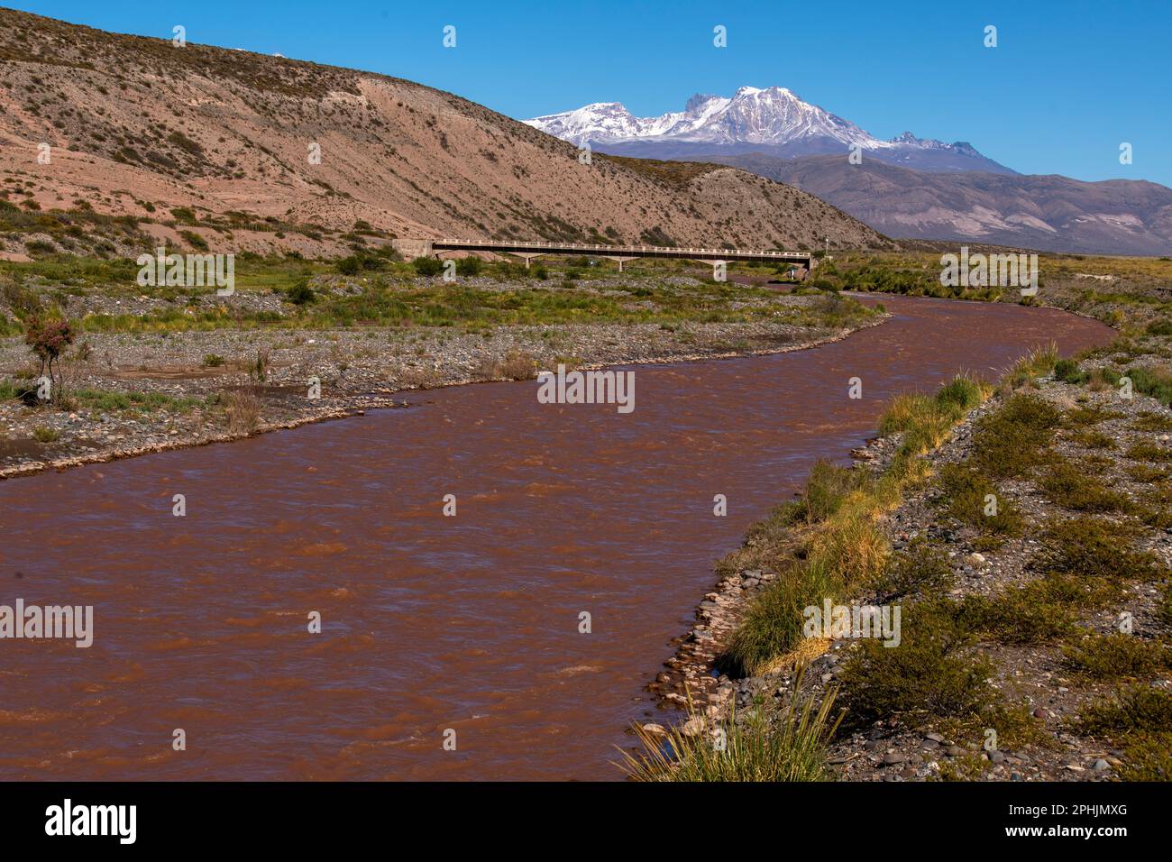 Atuel river at El Sosneado town with snow peaks of the Andes mountains ...
