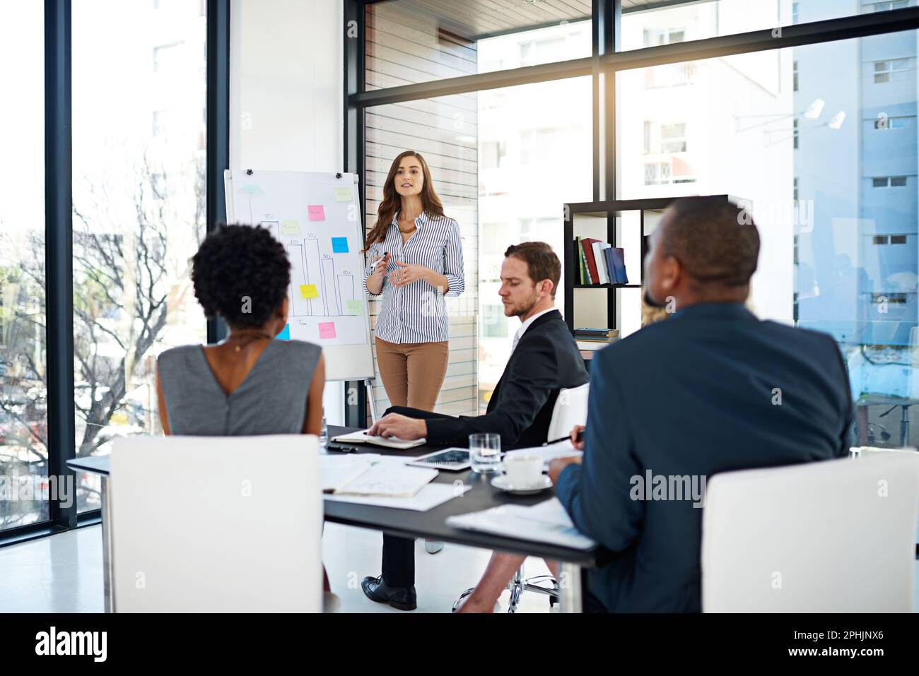 Thats an excellent point. a young businesswoman giving a presentation ...