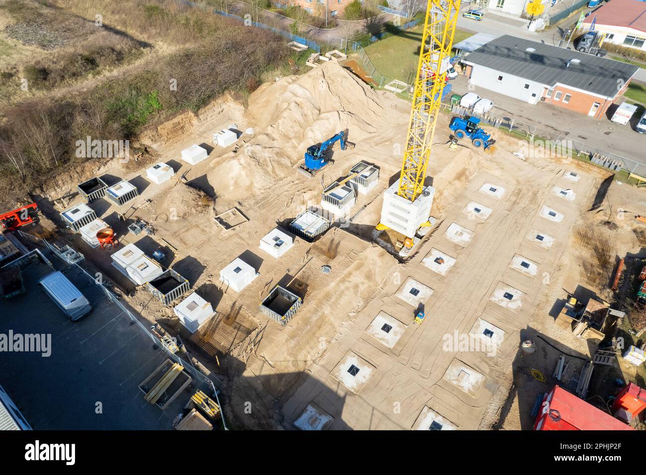 on a construction site large foundations are poured for the pillars of ...