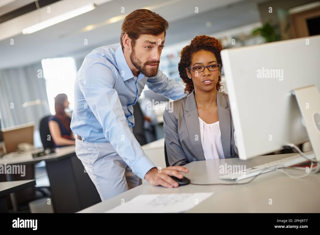 Technology and teamwork - the right tools for success. two coworkers ...