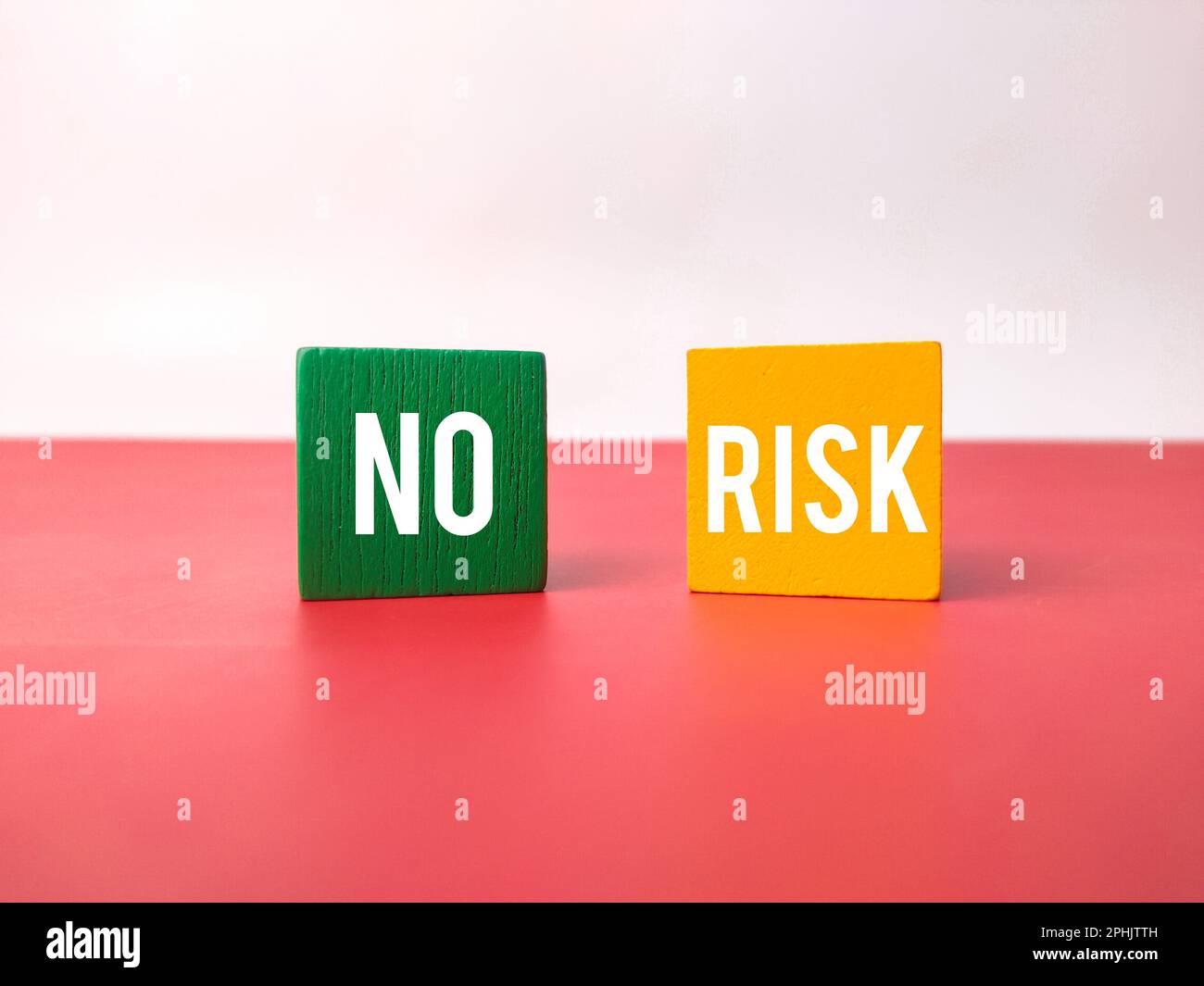 Colored cube with the word NO RISK on a white and red background ...