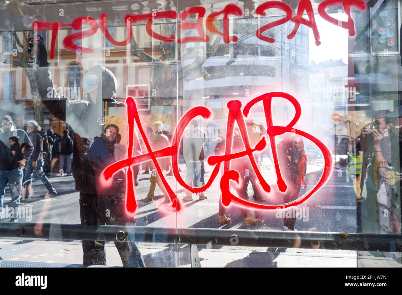 Toulouse, France. 28th Mar, 2023. Tag, ACAB on a window of a bus stop ...