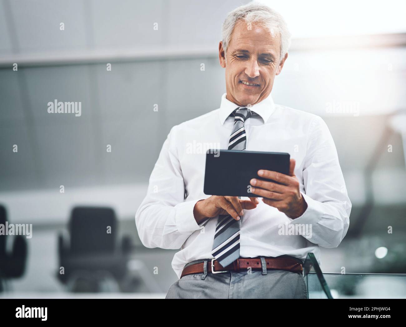 Its just the touch of a button away. a handsome mature businessman ...