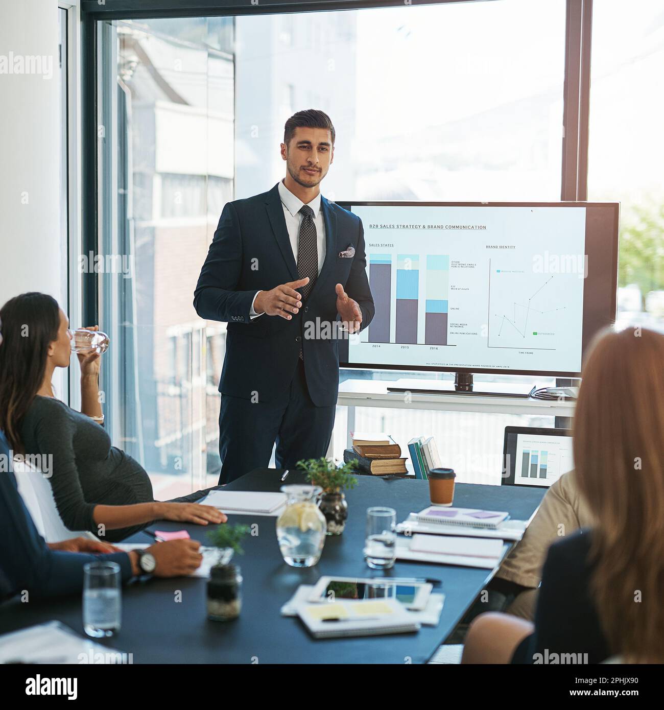 Giving a detailed explanation. a young businessman giving a ...