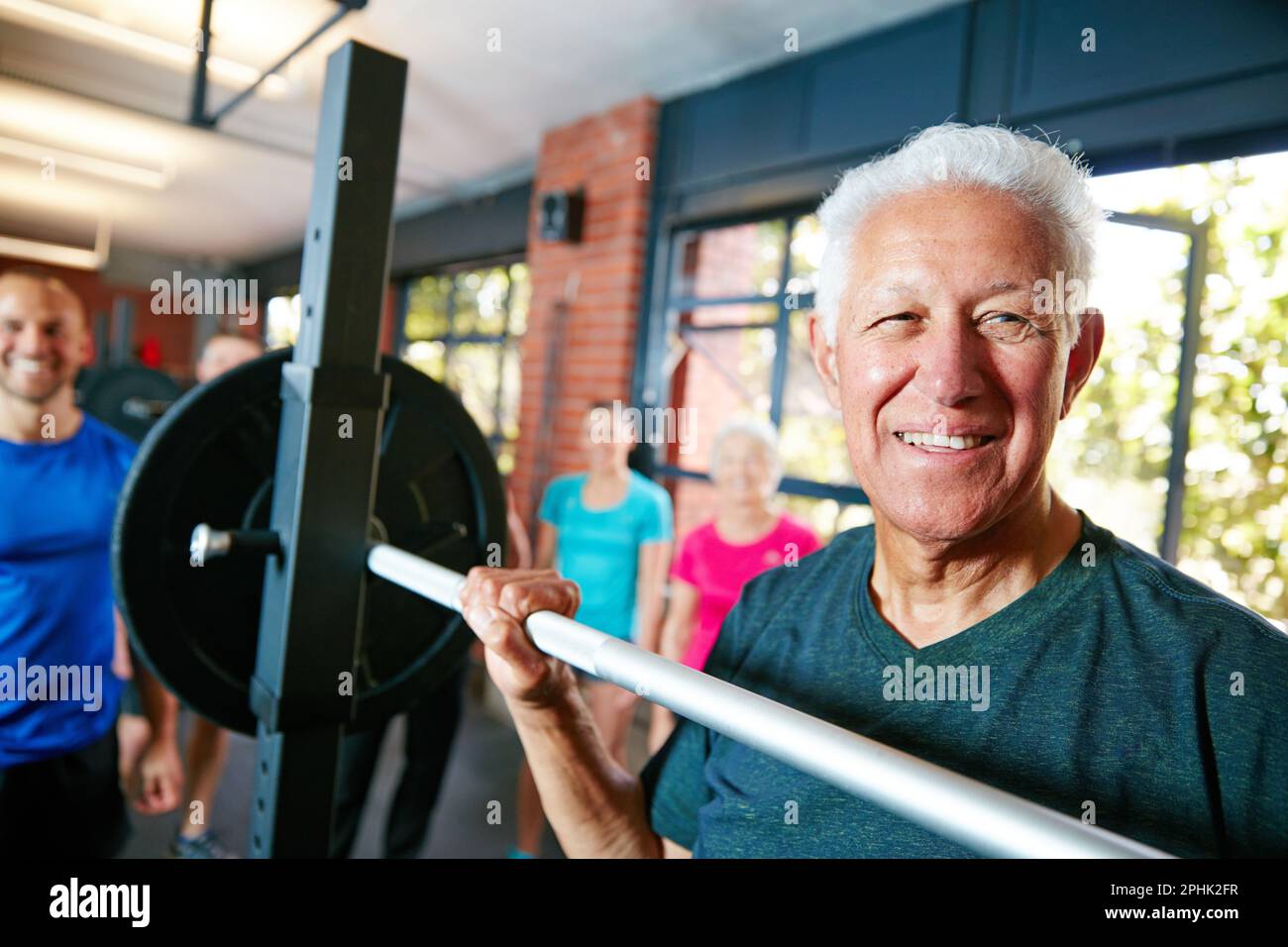 My retirement involves heavy metal. a senior man lifting weights while ...