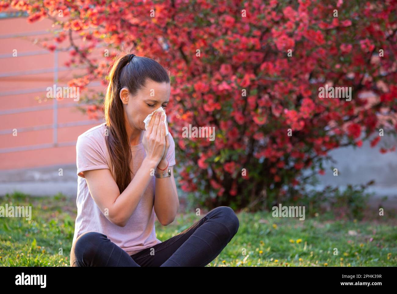 Pretty young woman having alergy symptoms from blooming tree pollen in ...