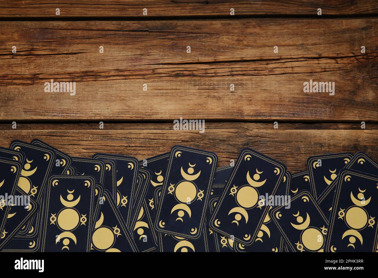 Tarot cards on wooden table, top view and space for text. Reverse side ...