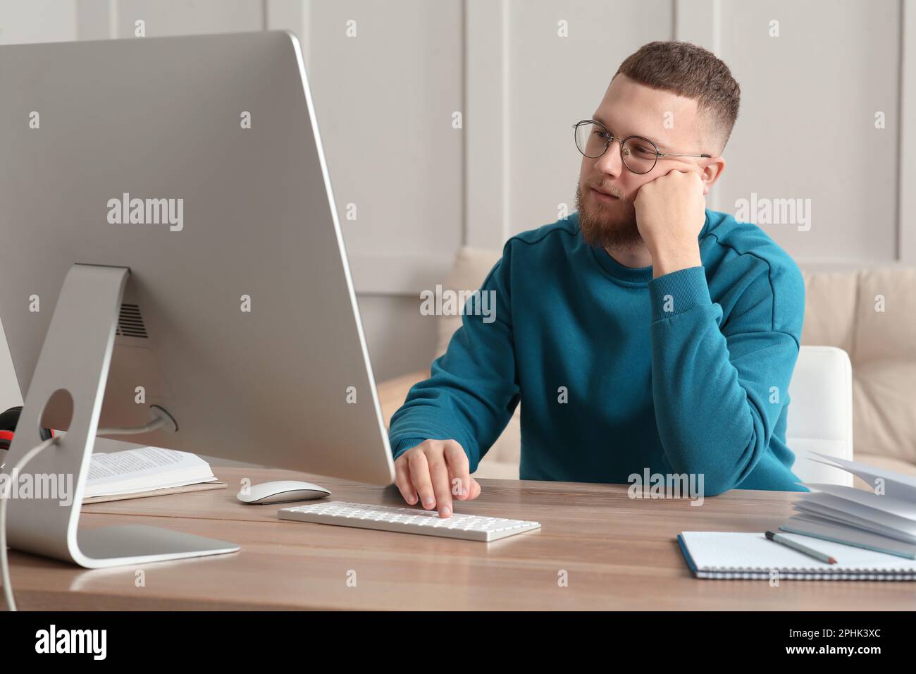 Online test. Man studying with computer at home Stock Photo - Alamy