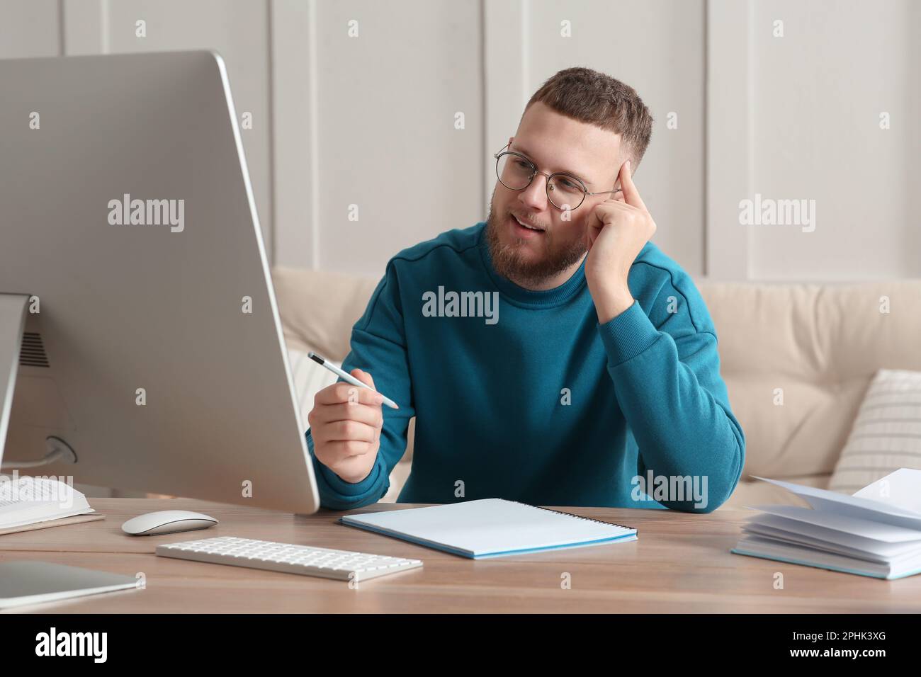 Online test. Man studying with computer at home Stock Photo - Alamy