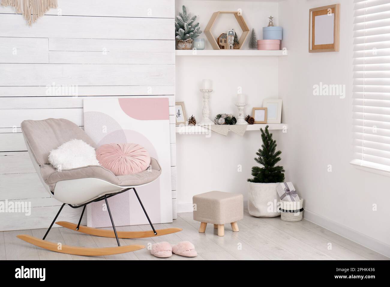 Stylish room interior with rocking chair, wall shelves and beautiful ...