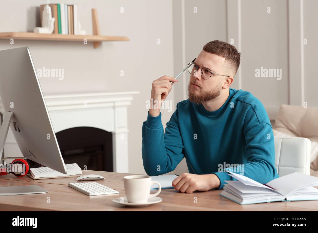 Online test. Man studying with computer at home Stock Photo - Alamy