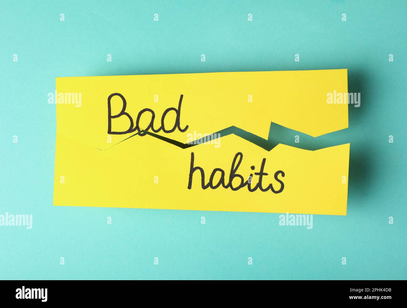 Torn paper with words Bad Habits on turquoise background, top view ...