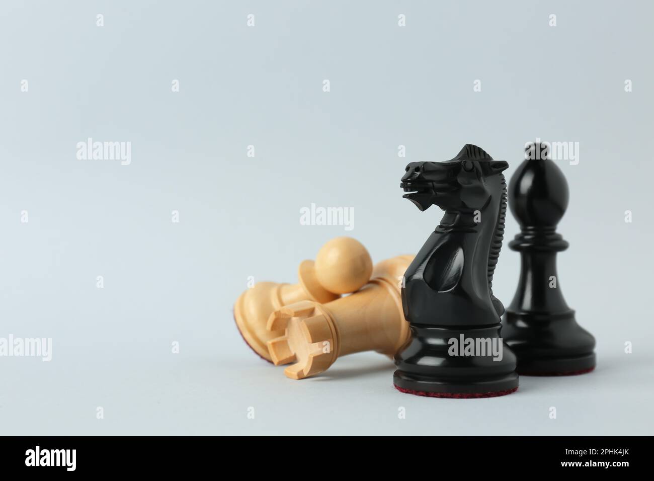 Different chess pieces on light background. Space for text Stock Photo ...