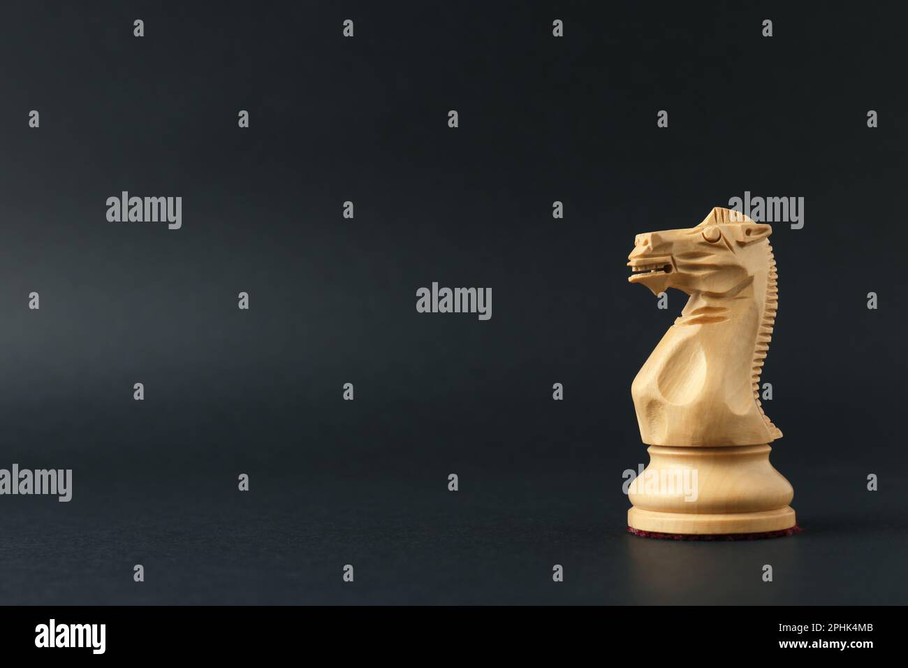 Wooden knight on dark background, space for text. Chess piece Stock ...