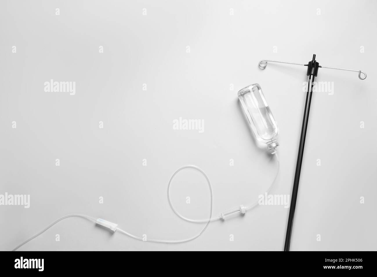 IV infusion set on light grey background, flat lay. Space for text ...