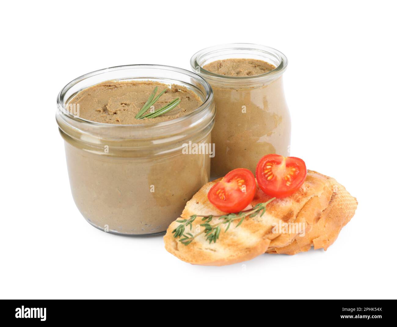 Glass jars with tasty liver pate, bread and tomato on white background ...