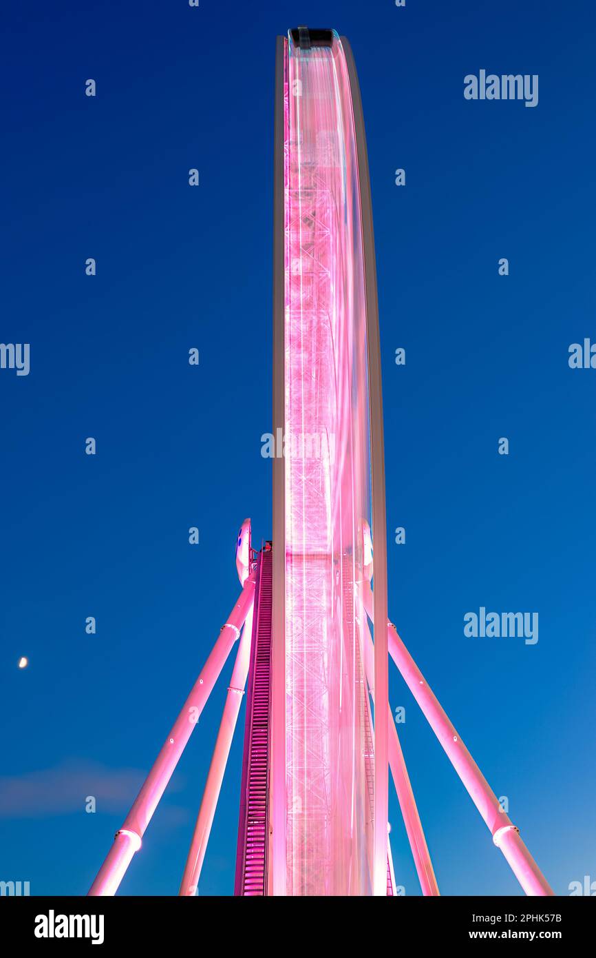 An illuminated Ferris wheel stands out against the night sky in ...