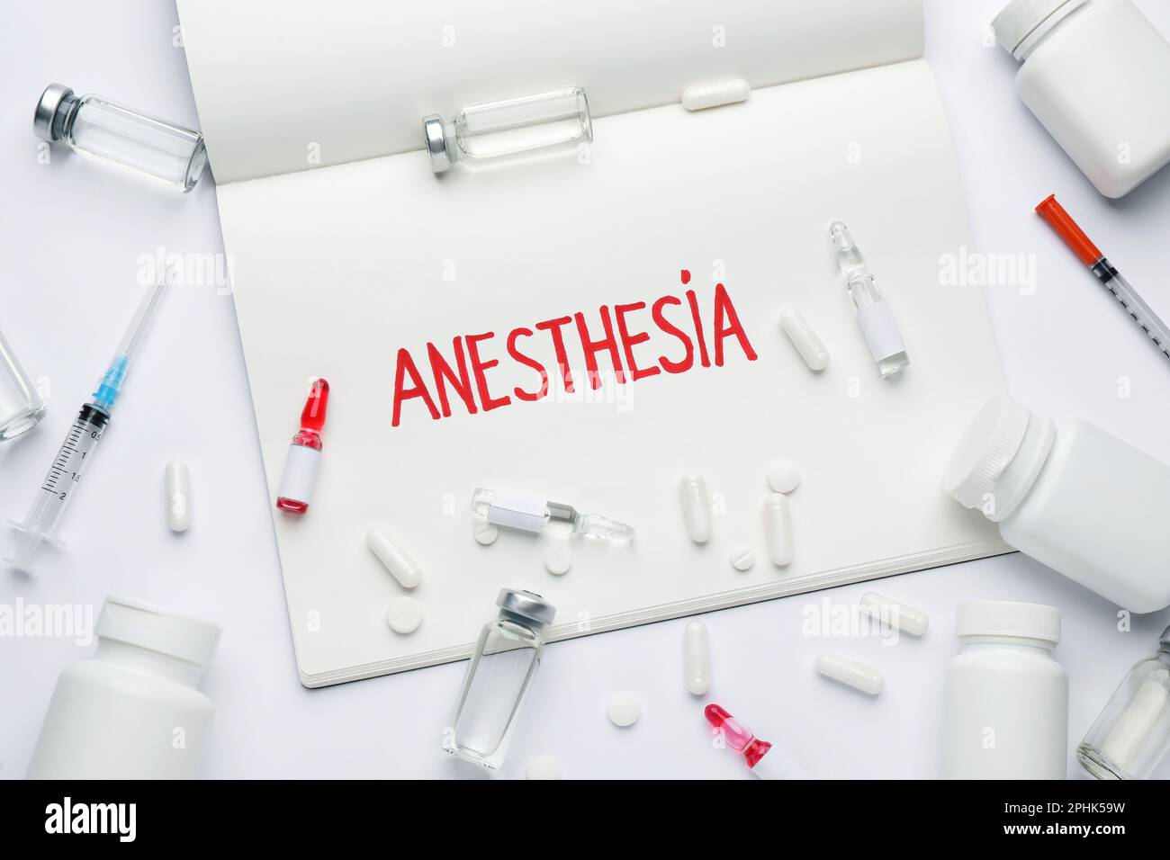 Notebook with word Anesthesia and drugs on white background, flat lay ...