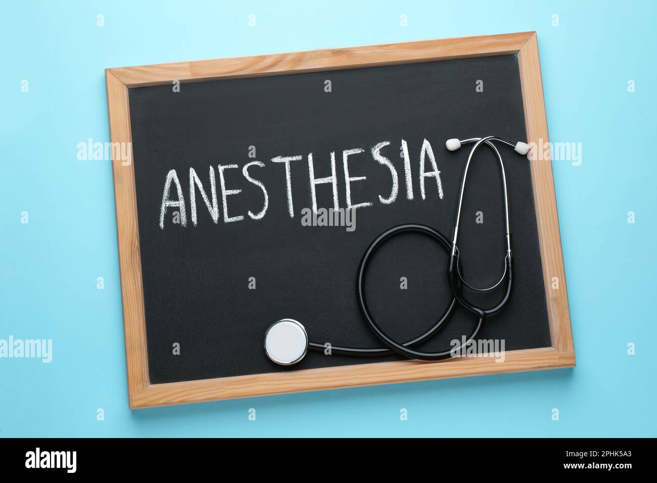 Blackboard with word Anesthesia and stethoscope on light blue ...