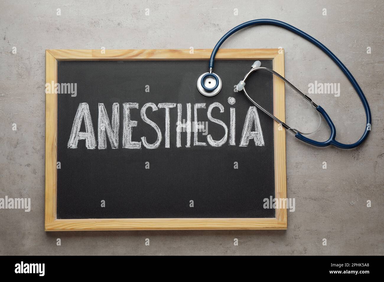 Blackboard with word Anesthesia and stethoscope on grey table, top view ...
