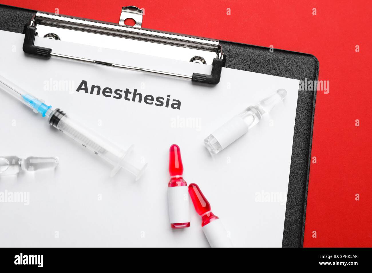Clipboard with word Anesthesia, syringe and ampules on red background ...
