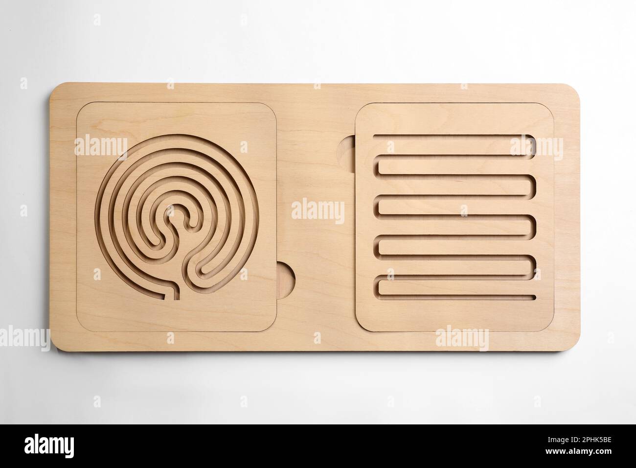 Wooden finger labyrinths on white background, top view. Montessori toy ...