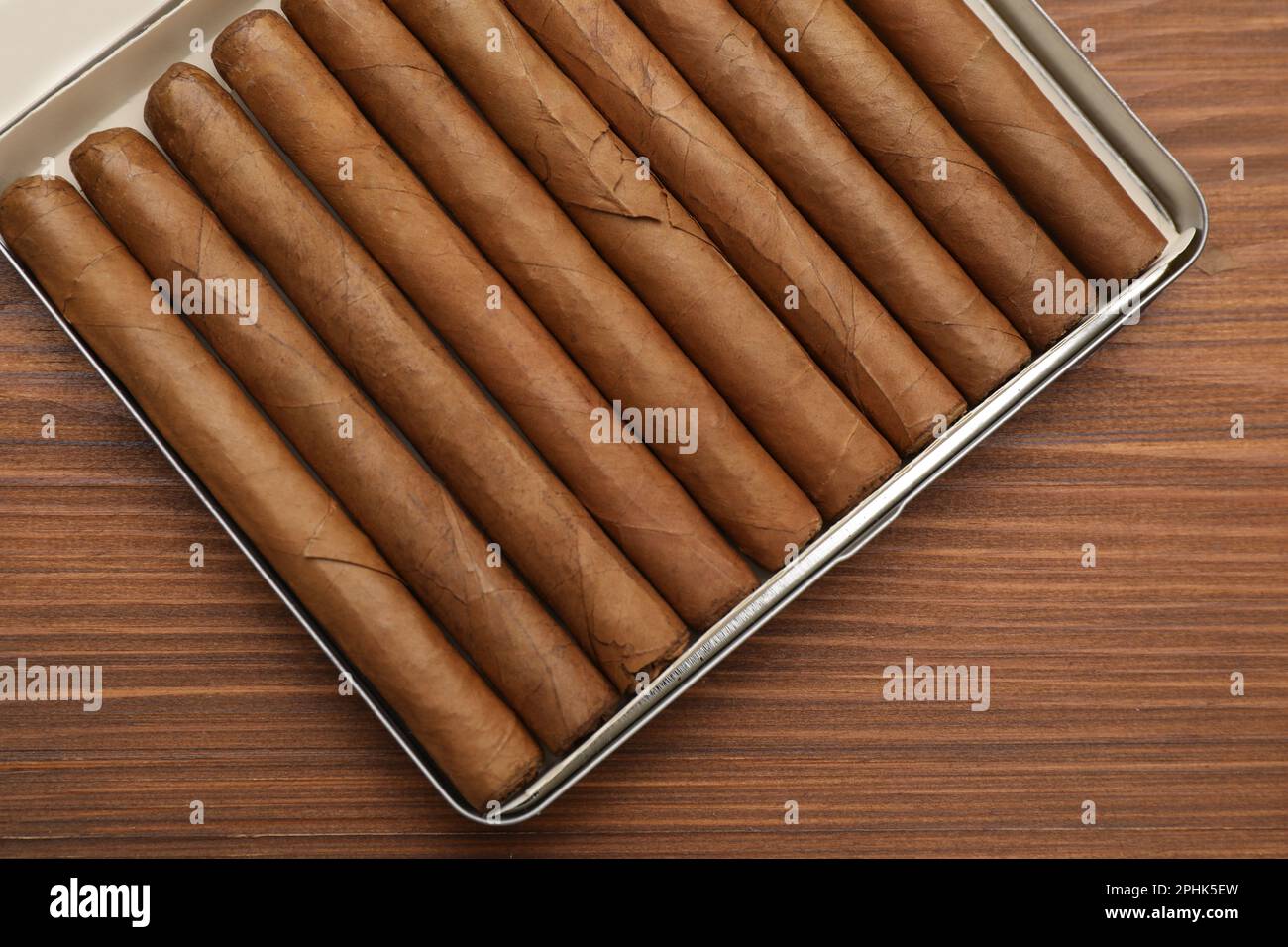 Box with expensive cigars on wooden table, top view Stock Photo - Alamy