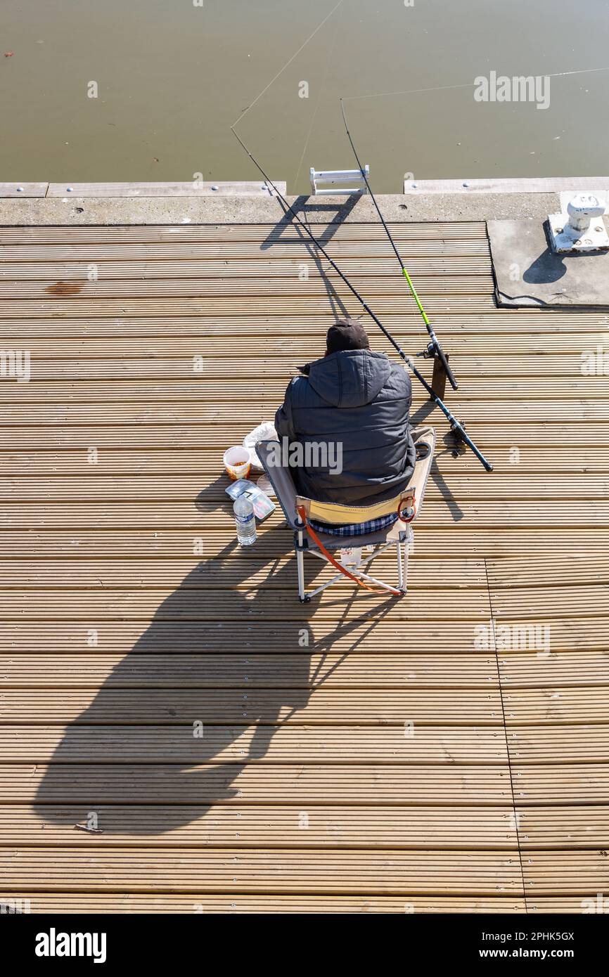 Man sitting in chair fishing hi-res stock photography and images - Alamy