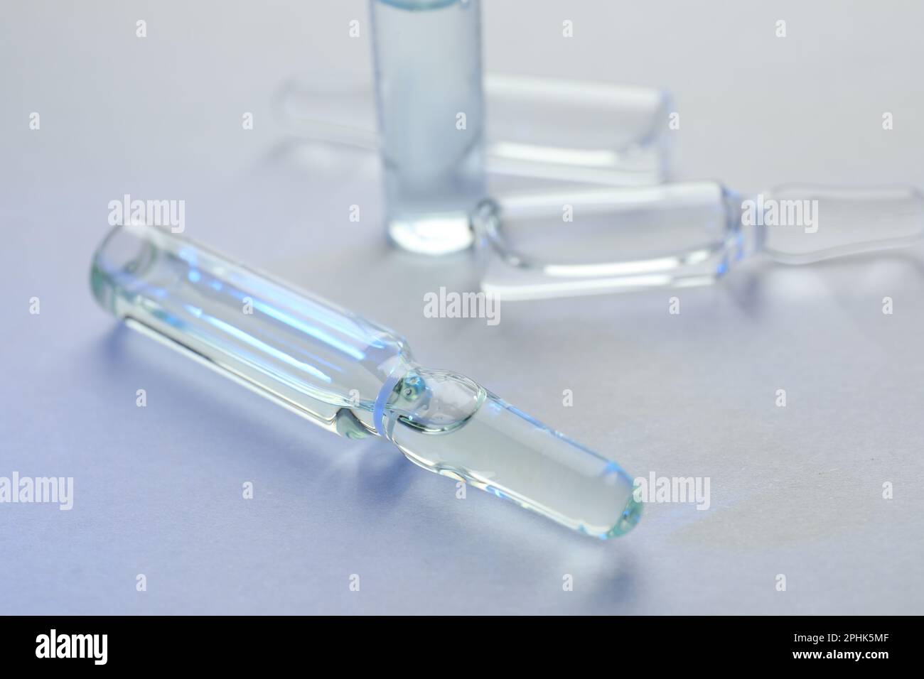 Pharmaceutical ampoules with medication on white background, closeup ...