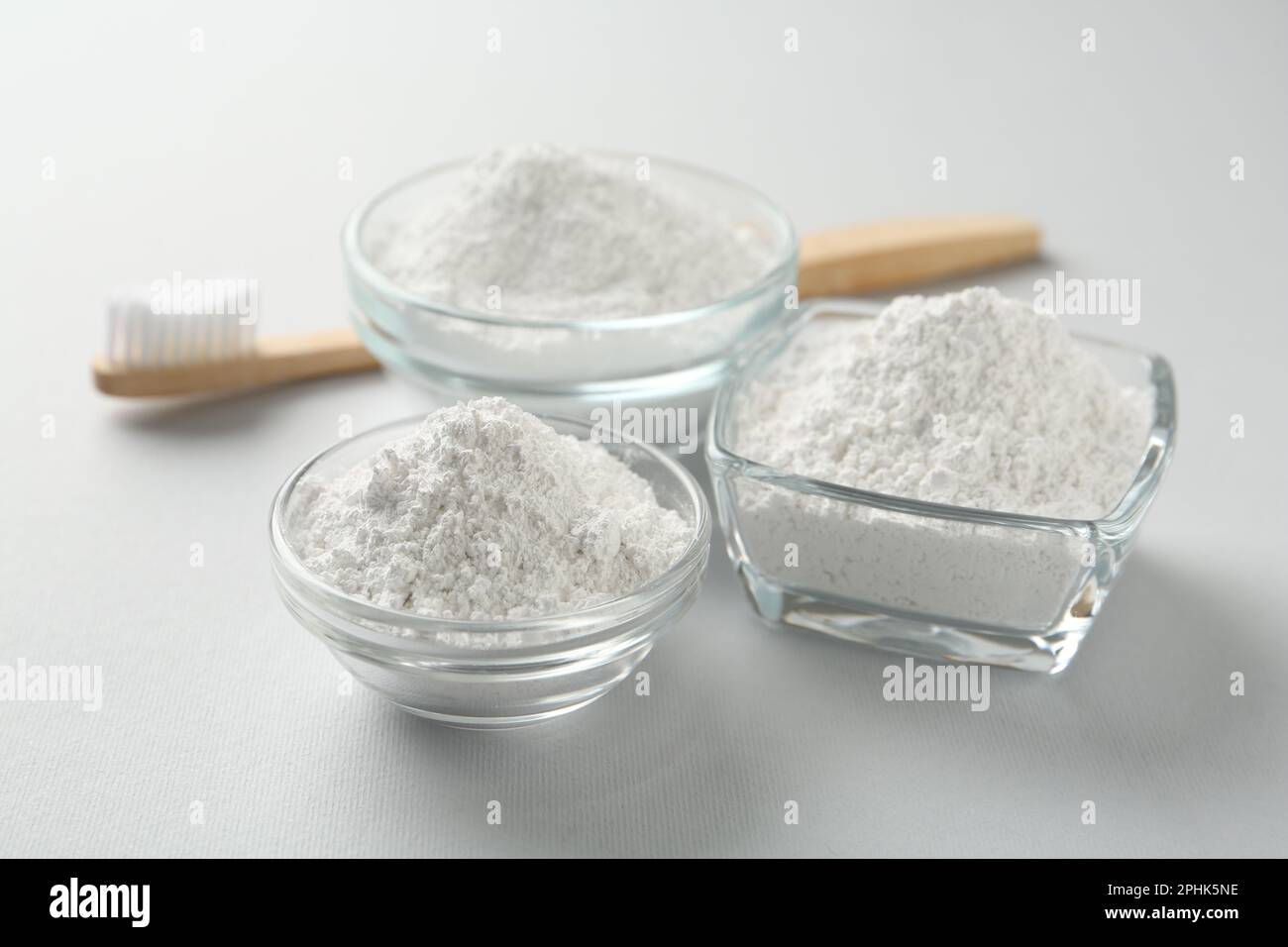 Tooth powder and brush on white background Stock Photo - Alamy
