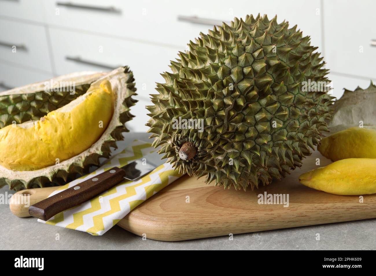 Fresh ripe durian fruits on grey table in kitchen, closeup Stock Photo ...