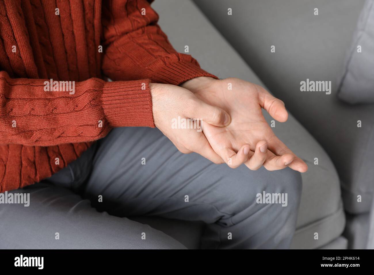 Man suffering from trigger finger indoors, closeup Stock Photo - Alamy