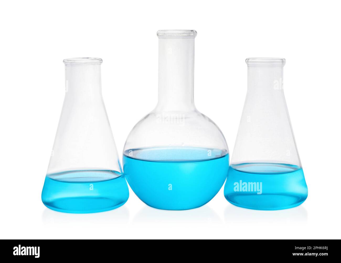 Different laboratory glassware with light blue liquid on white ...
