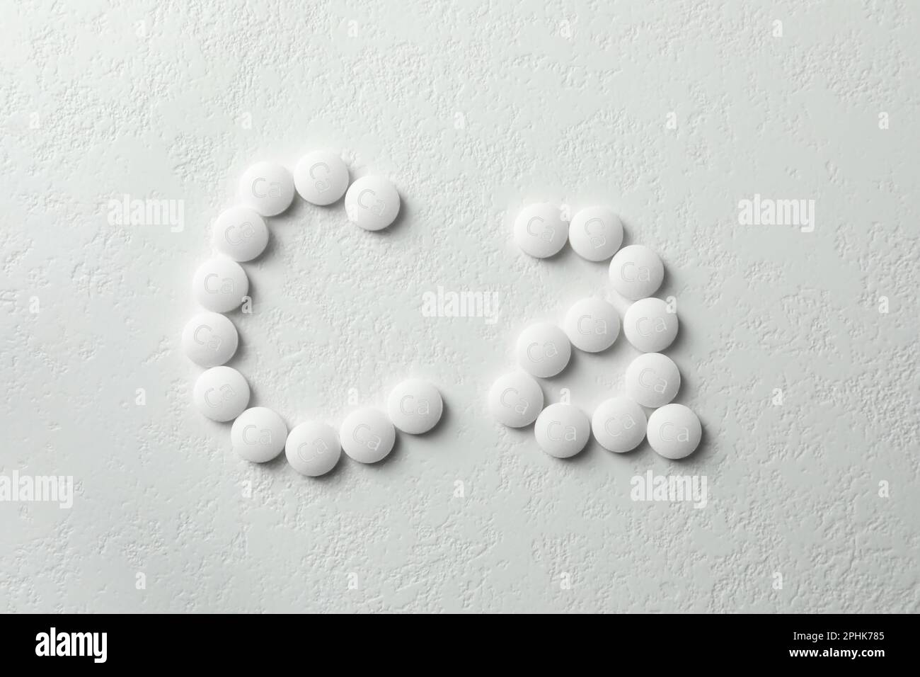 Flat lay composition with calcium supplement pills on white background ...