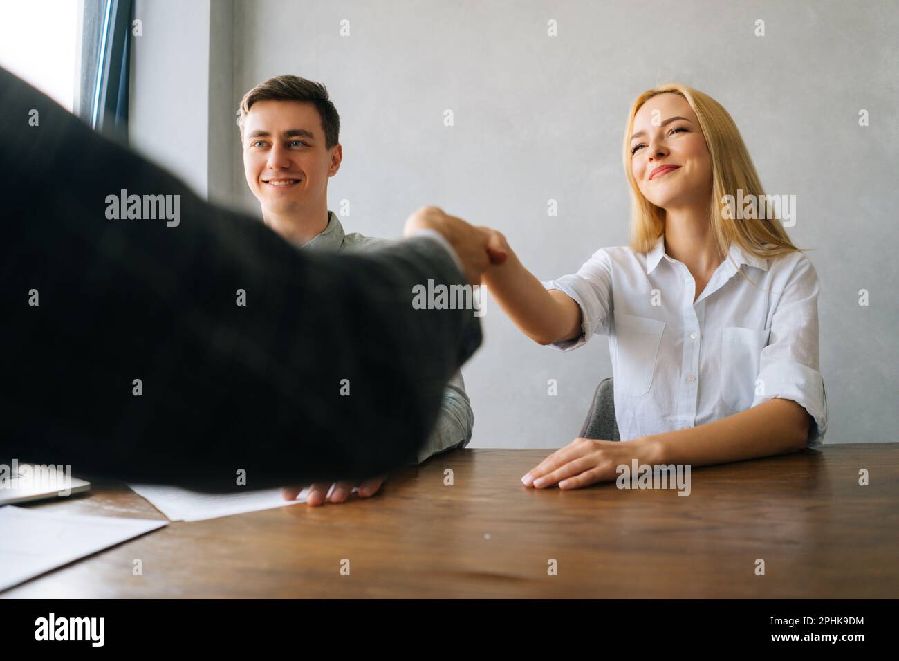 Three partners signing contract handshaking hi-res stock photography ...