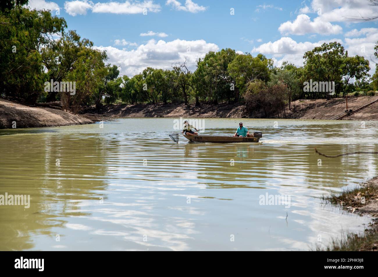 Local residents cleaning up after the fish death event in Menindee, NSW ...