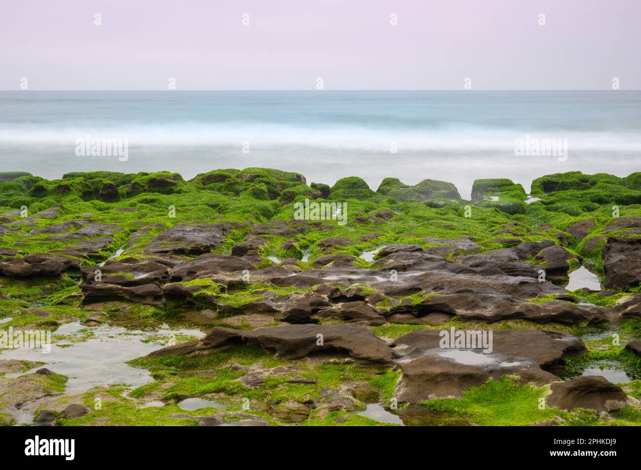 White waves wash over mossy brown rocks. Explore breathtaking coastal ...