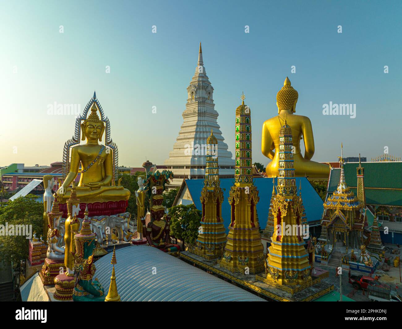 aerial view golden big Buddha Wat Paknam Phasi Charoen in sunset. beautiful sunset reflection on ...