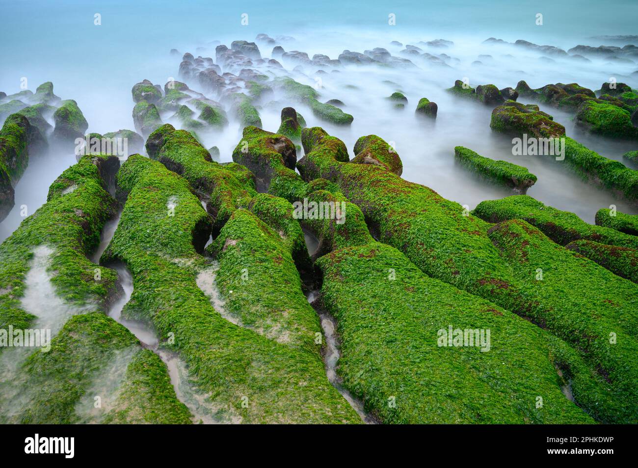 White waves wash over mossy brown rocks. Explore breathtaking coastal ...