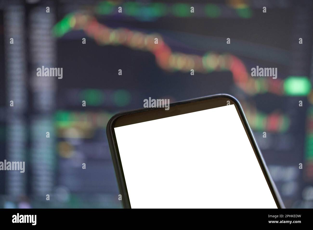 Black phone with blank mockup screen on rising stock graph. Closeup ...